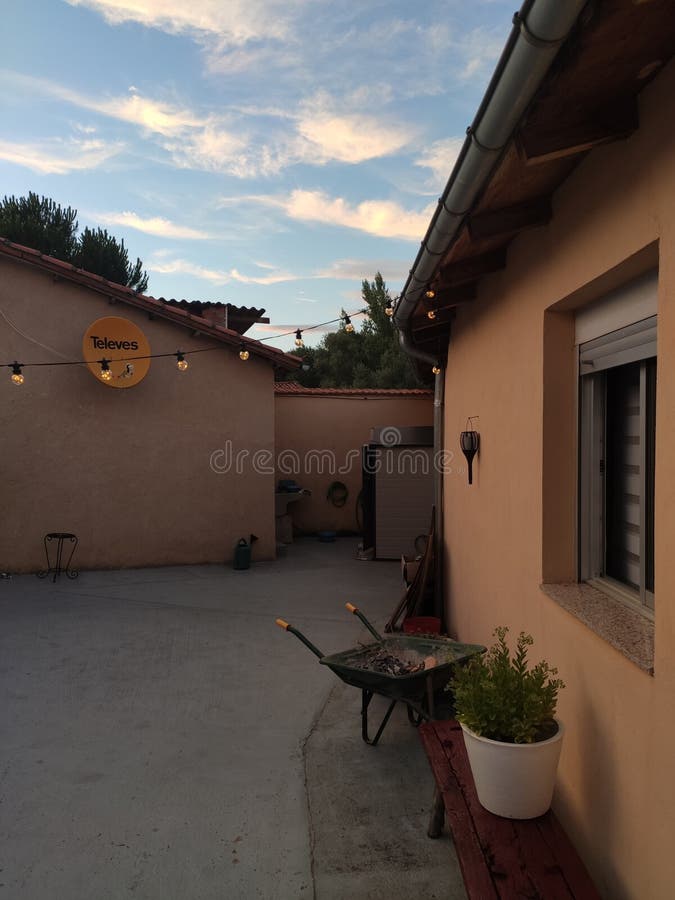 Rustic Courtyard of a Spanish Countryside Home at Dusk with Cloudy Sky ...