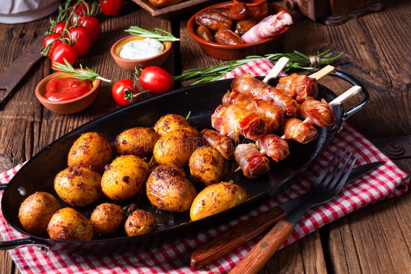 Rustic Dates Wrapped in Bacon and Young Roasted Potato Stock Image ...