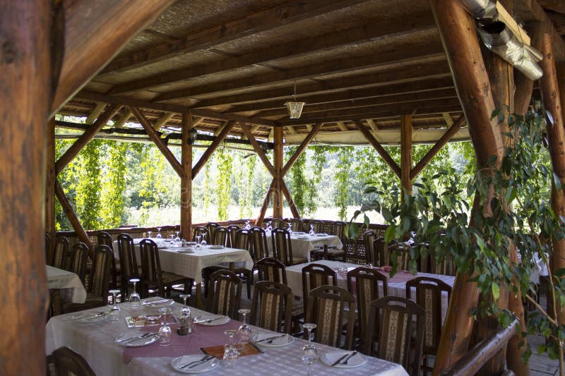 Rustic Dining Area in a Countryside Restaurant Surrounded by Greenery ...