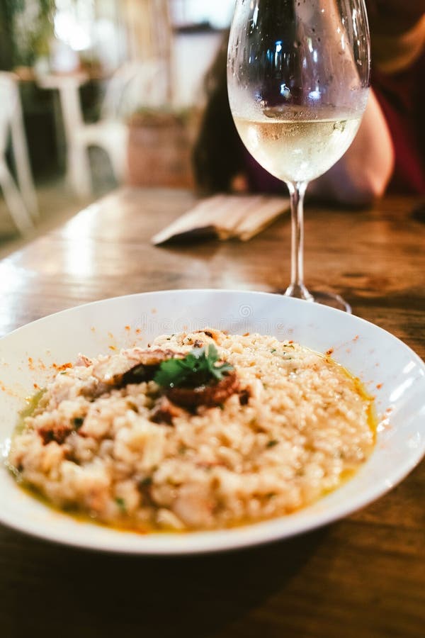 Rustic Dining with Risotto and Wine. Stock Image - Image of evening ...