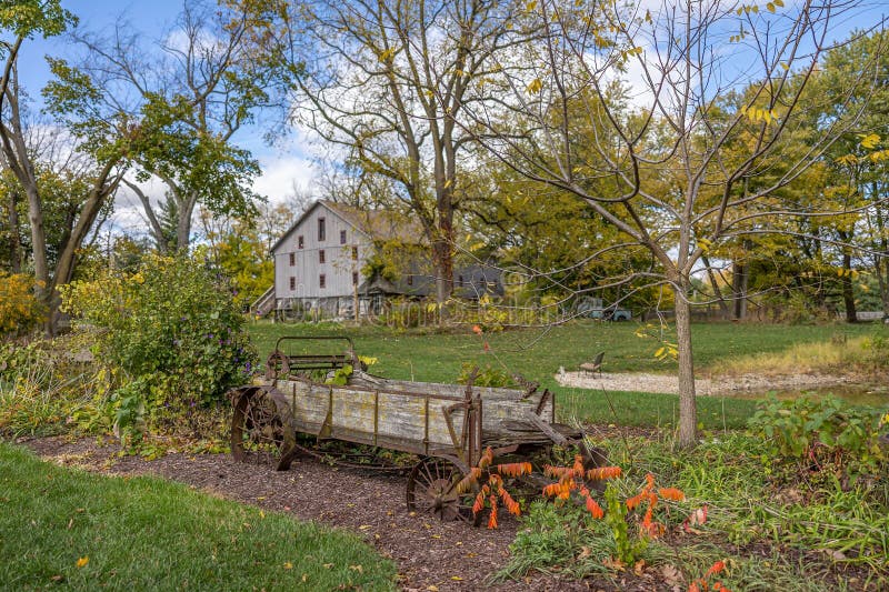 Rustic Farm Scene with a Manure Spreader and a Barn in the Background ...