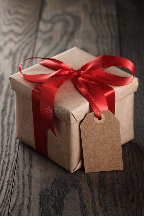Rustic Gift Box with Red Ribbon Bow and Empty Tag Stock Image - Image ...