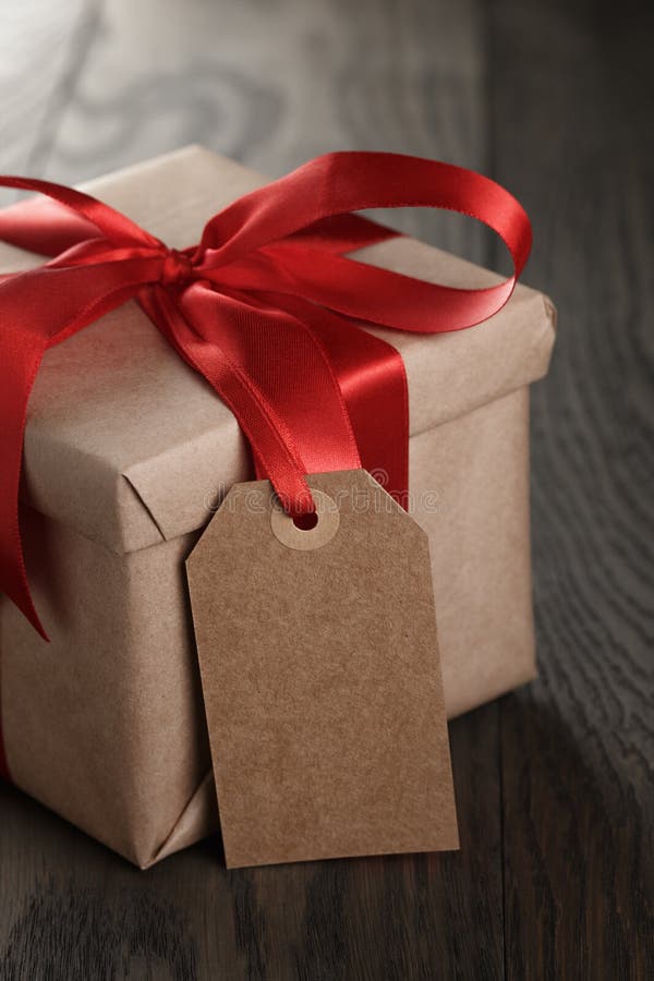 Rustic Gift Box with Red Ribbon Bow and Emmpty Tag Stock Photo - Image ...