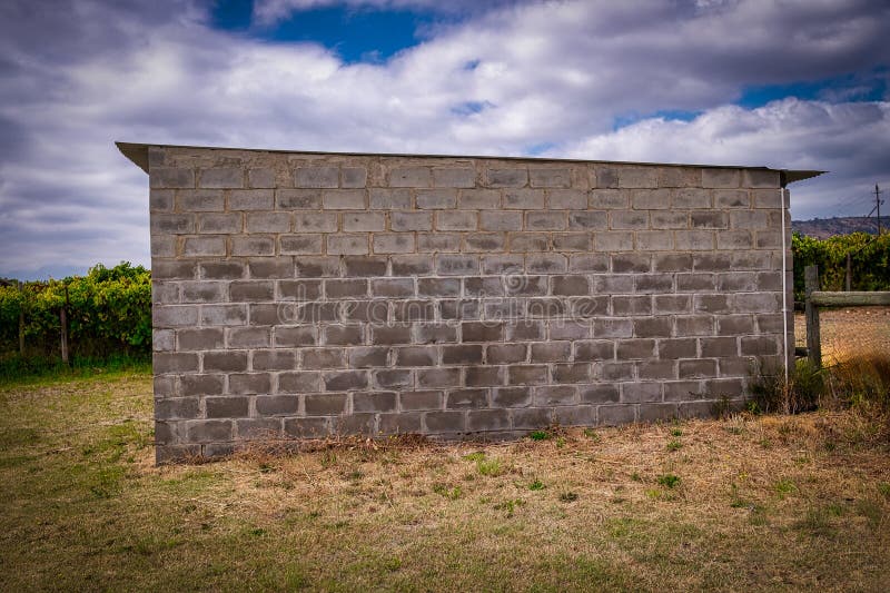 Rustic Grey Brick Farm Building with Vineyard Backdrop Stock Image ...