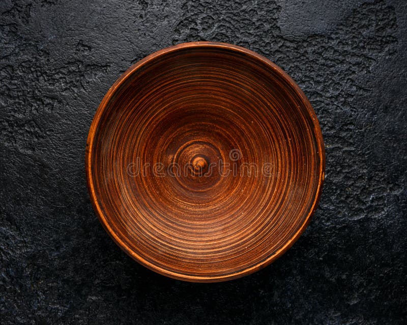 Rustic Handmade Brown Clay Bowl Plate on Black Background Stock Image ...