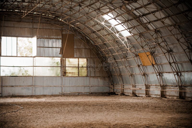 Rustic Indoor Arena with Natural Light Streaming through High Windows ...