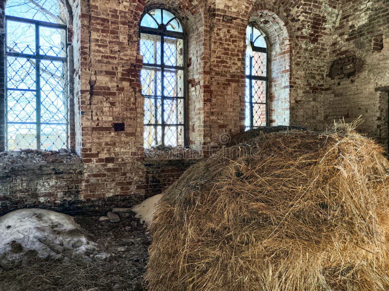 Rustic Interior of an Abandoned Building with a Large Hay Bale and Worn ...