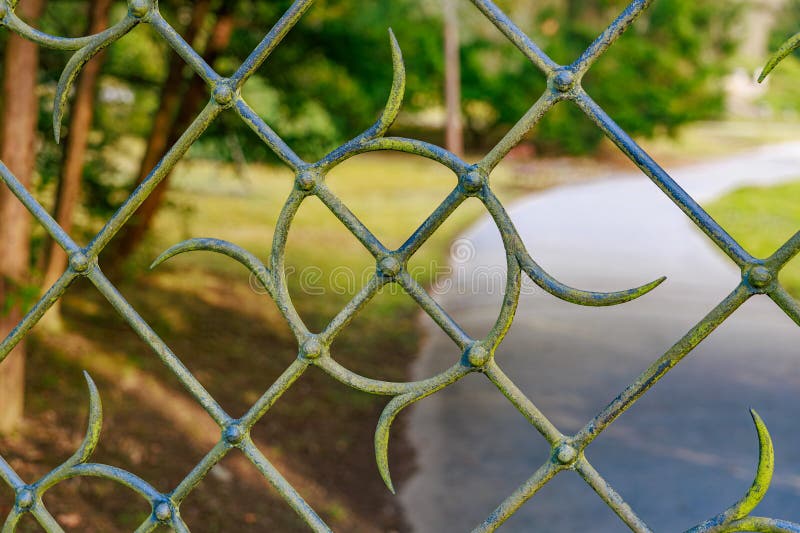 Rustic Iron Fence with Moon Design in Lush Garden Setting Stock Photo ...