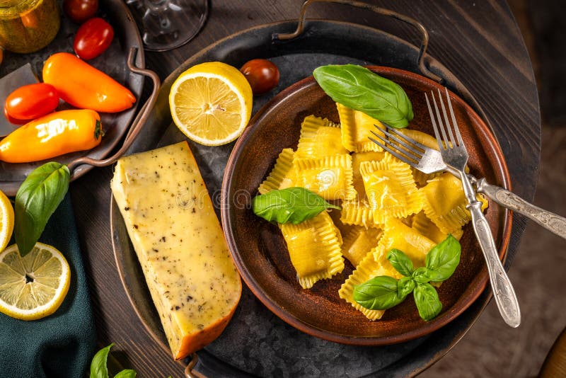 Rustic Italian Dinner Setting with Ravioli, Cheese and Basil Leaves ...
