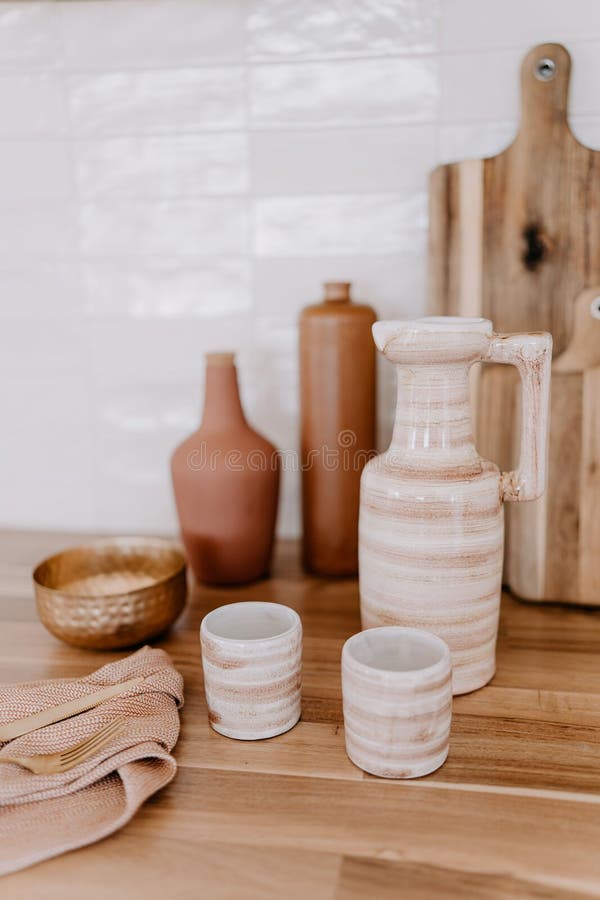 Rustic Kitchen Countertop with a Selection of Ceramic Pots and Bowls on ...