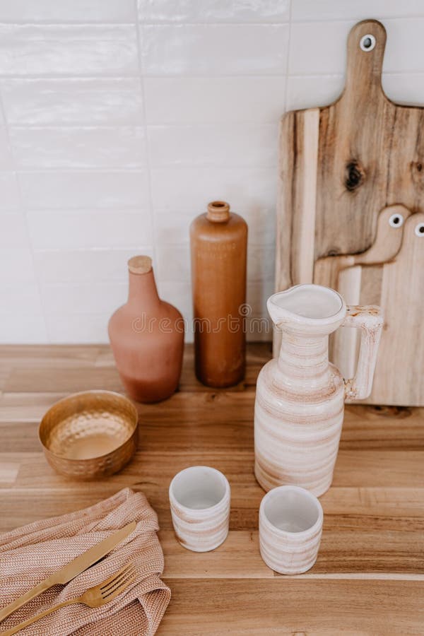 Rustic Kitchen Countertop with a Selection of Ceramic Pots and Bowls on ...