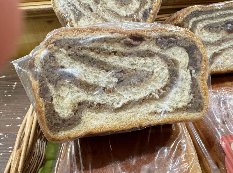 Rustic Marble Rye Bread with Swirled Pattern Wrapped in Plastic on ...
