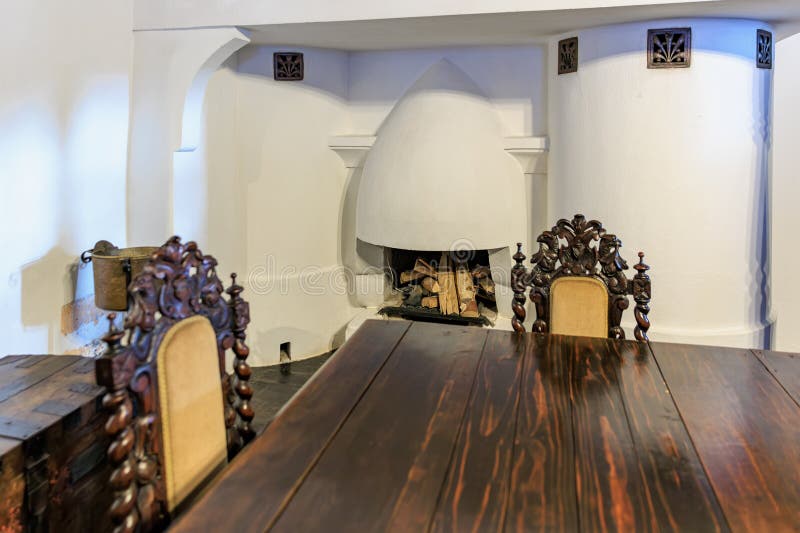 Rustic Medieval Dining Room with Ornate Chairs and Stone Fireplace ...