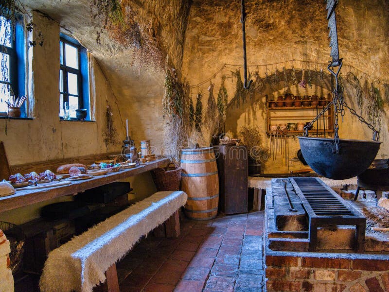 Rustic Medieval Kitchen with Large Cauldron and Herbs Stock Photo ...