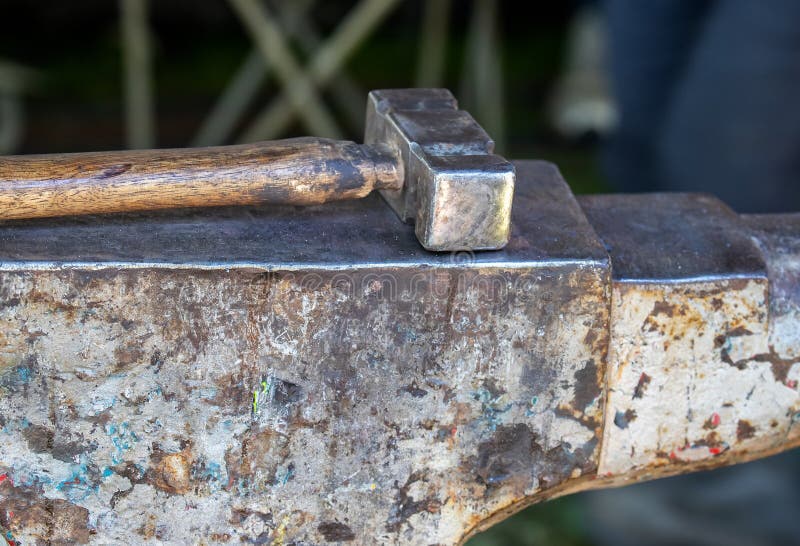 Rustic Metal Anvil and Hammer on Grass, Representing Traditional ...