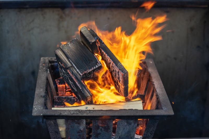 Rustic Metal Fire Basket.Burning Wood in Fire Basket Stock Image ...