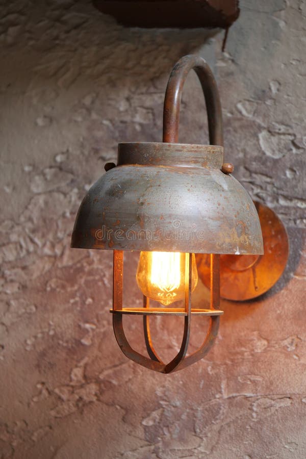 Rustic Metal Lamp Hanging on a Textured Wall in Warm Lighting Stock ...