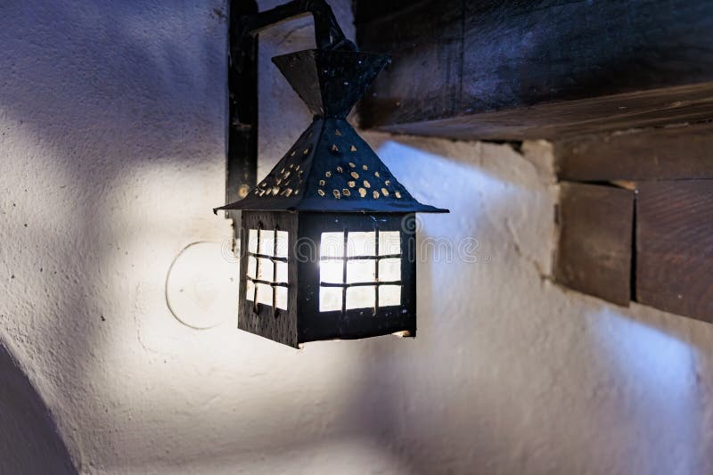 Rustic Metal Lantern Illuminating a Cozy Rustic Interior Wall Stock Photo - Image of lantern ...