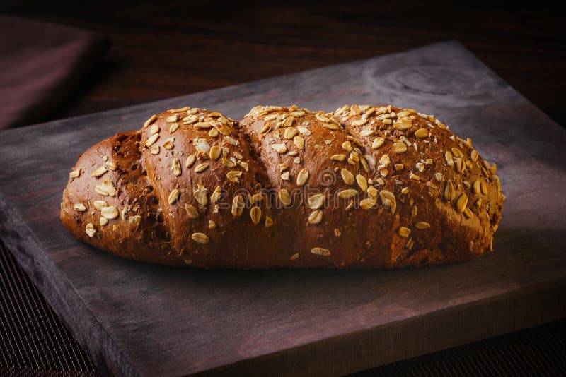 A Rustic Oat Bread, on a Wooden Board on a Fine Table Stock Photo ...