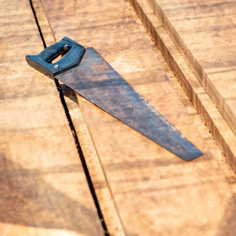 Rustic Old Hand Saw on Timber Stack at Construction Site Stock Photo ...