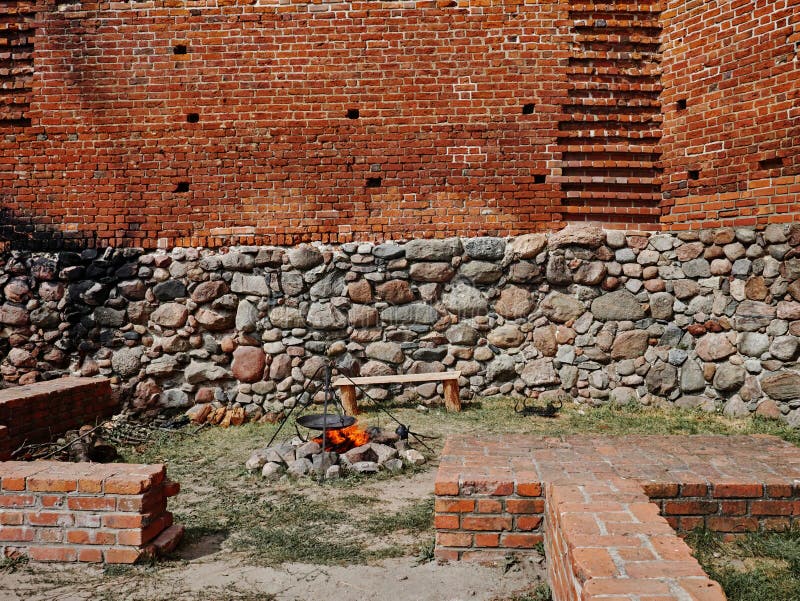 A Rustic Outdoor Scene Featuring a Small Campfire Burning Brightly in ...