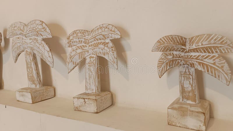 Rustic Palm Tree Sculptures on Minimalist Shelf Stock Image - Image of ...