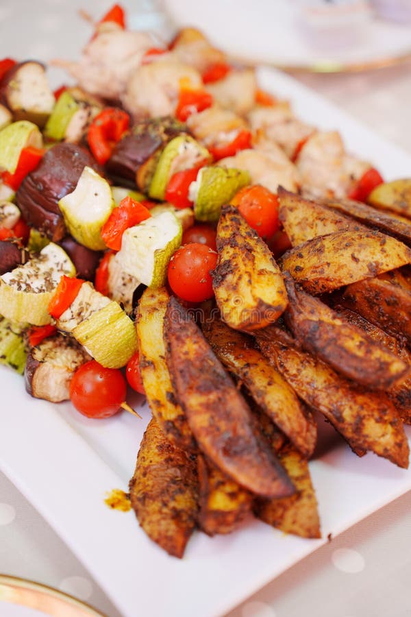 Rustic Potatoes and Vegetable Kebabs on the Grill on the Banquet Table ...
