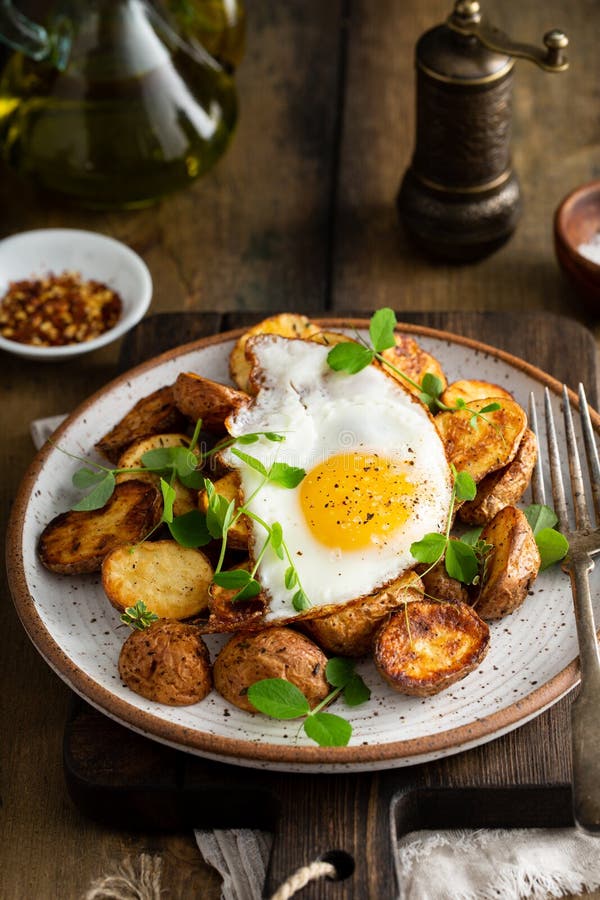 Rustic Roasted Potatoes with Fried Egg for Breakfast Stock Photo ...
