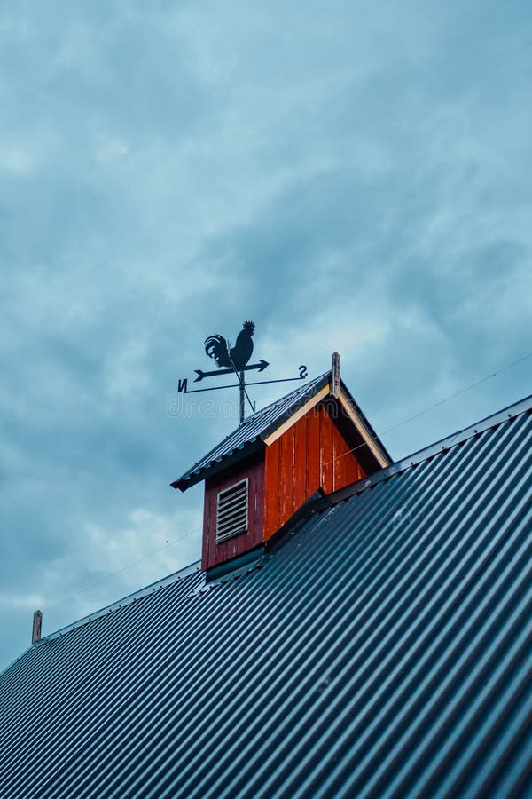 A Rustic Rooftop Featuring a Weather Vane Set Against a Dramatic ...