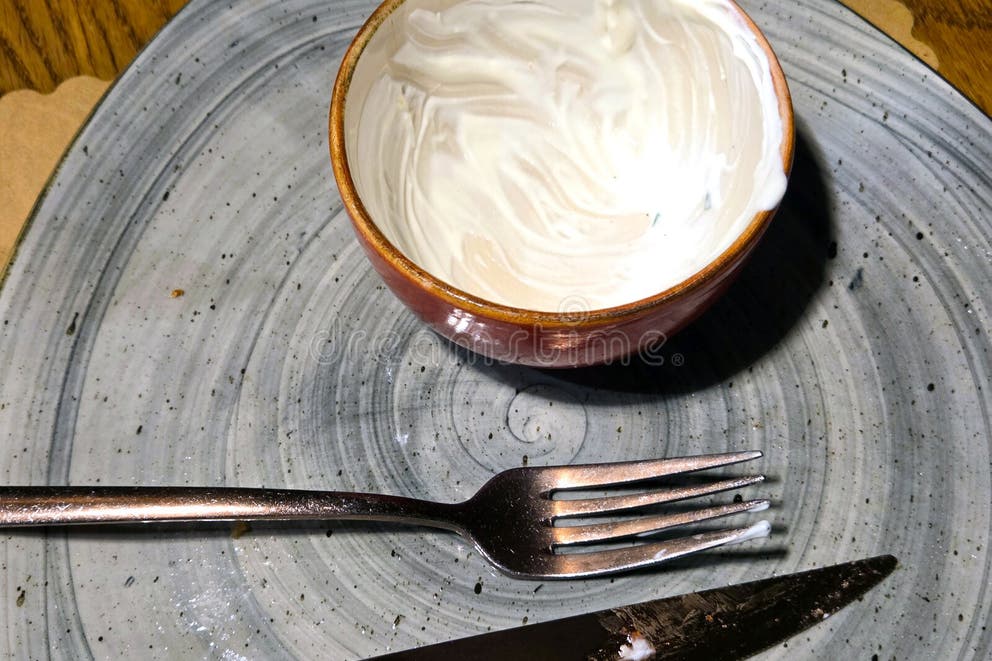 Empty Dessert Bowl on Rustic Plate with Fork and Knife - Dining Concept ...