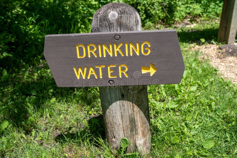 Rustic Sign Pointing To a Source of Drinking Water at a Campground and ...
