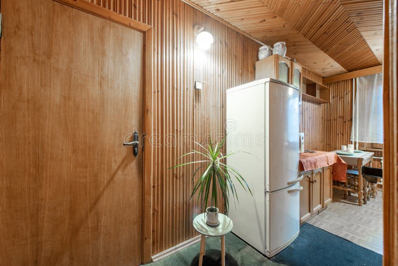 Rustic Small Kitchen Interior with Wooden Walls and Compact Dining Area ...