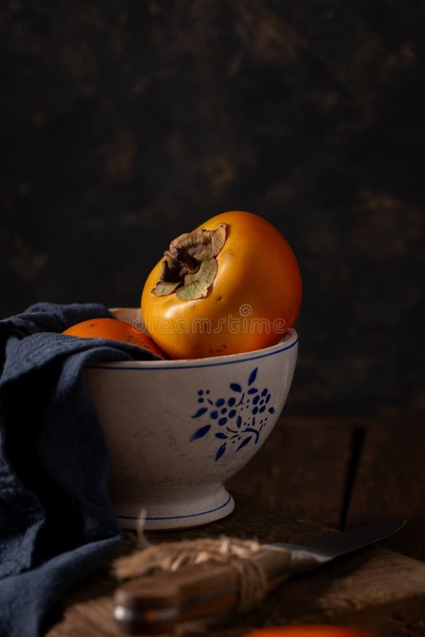 Rustic Still Life of Persimmons in a Patterned Bowl Stock Image - Image ...