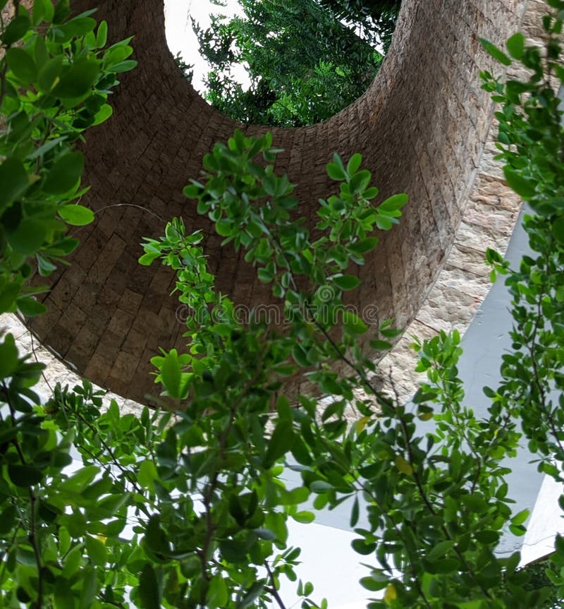 A Rustic Stone Arch Framed by Lush Green Foliage, Blending Nature and ...