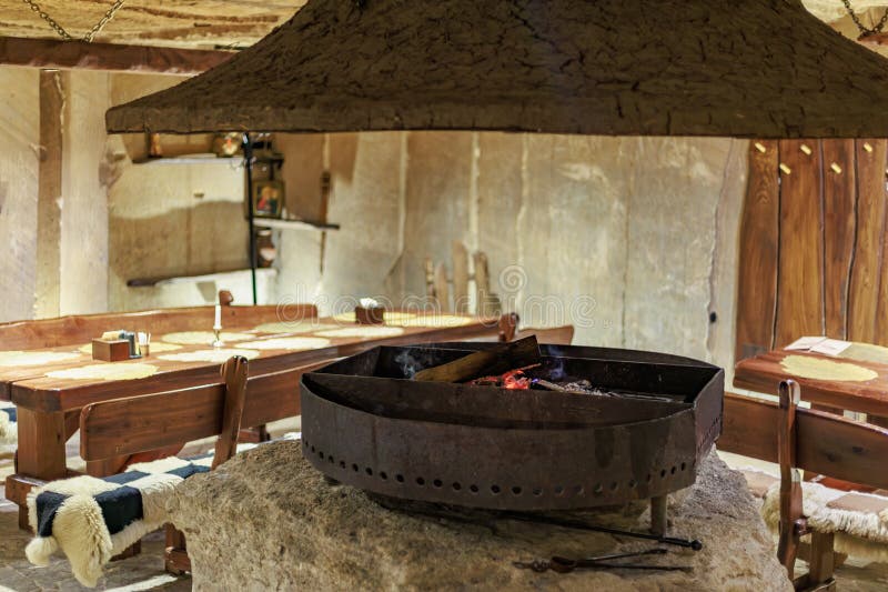 Rustic Stone Interior with Large Fireplace and Wooden Dining Table ...