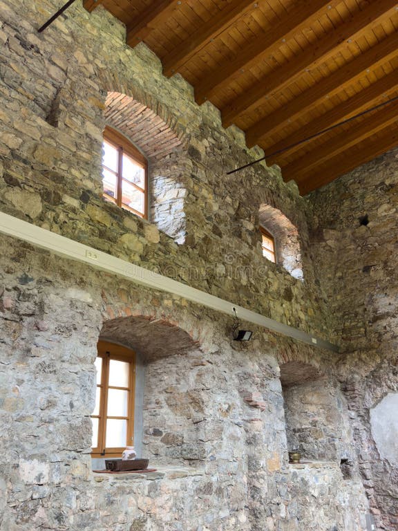 Rustic Stone Interior with Wooden Ceiling and Arched Windows in ...