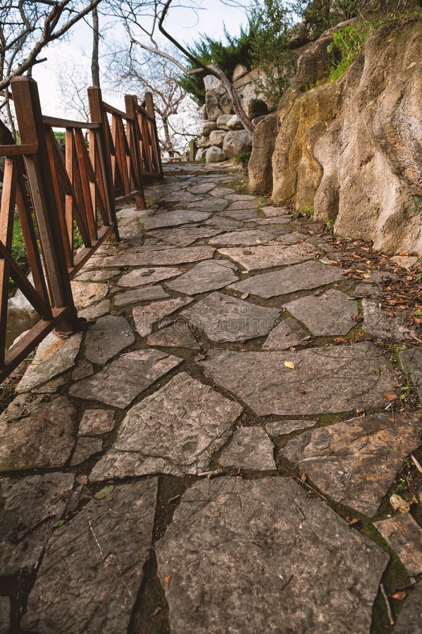 Rustic Stone Path Curves beside Wooden Fence Stock Image - Image of ...