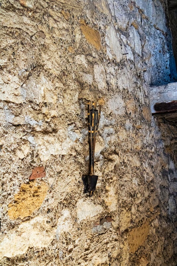 Rustic Stone Wall Adorned with Traditional Tools in a Historical ...