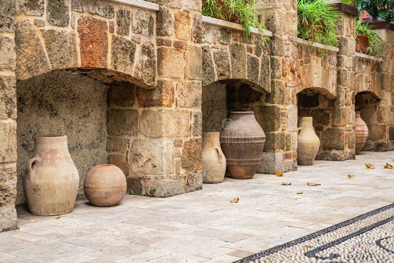 Rustic Stone Wall with Clay Pots in a Mediterranean Courtyard Stock ...