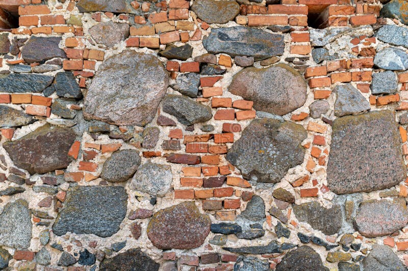 A Rustic Stone Wall Features Various Shapes and Tones of Natural Stones ...