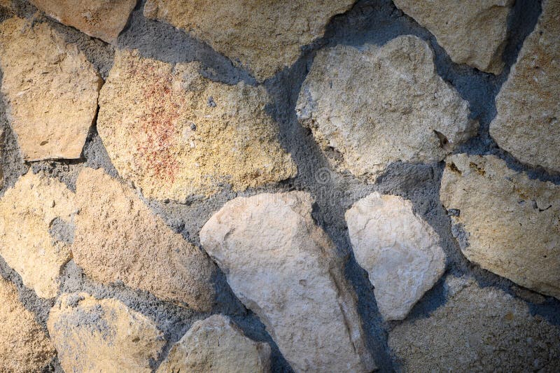 Rustic Stone Wall Showcases Natural Textures and Earthy Tones in Warm ...