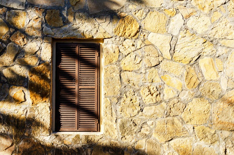 Rustic Stone Wall with Wooden Shuttered Window Stock Image - Image of ...