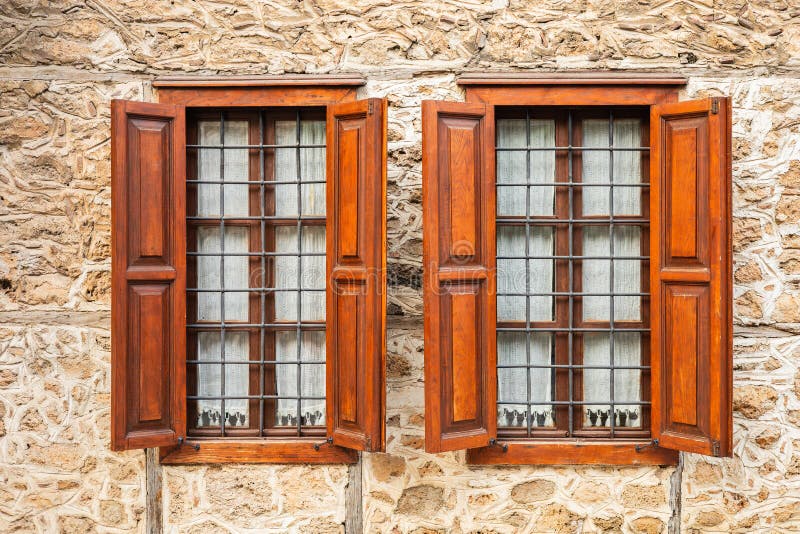 Rustic Stone Wall with Wooden Shuttered Windows Stock Image - Image of ...