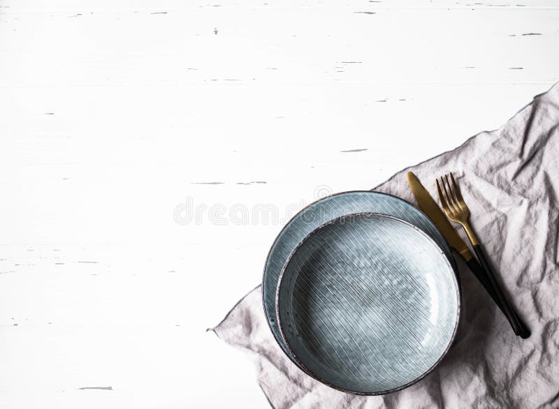 Rustic Table Setting with Blue Plates, Napkin and Appliances on White ...