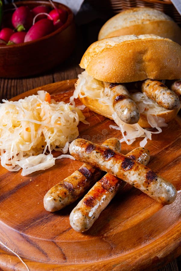 Rustic Thuringian Bratwurst with Sauerkraut and Roll Stock Photo ...