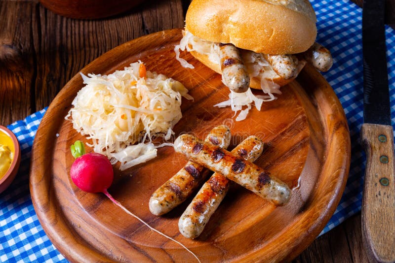 Rustic Thuringian Bratwurst with Sauerkraut and Roll Stock Photo ...