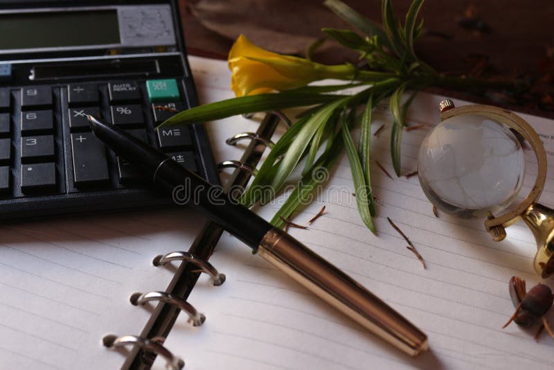 Rustic View of Professional Desk with Calculator Notebook and Pen on ...