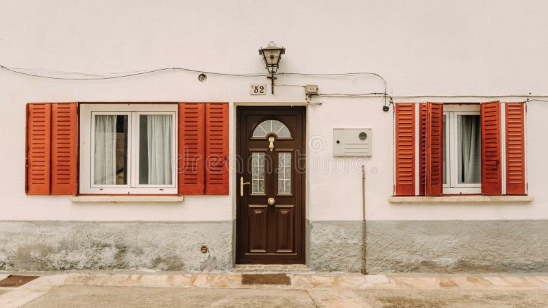 Rustic Vintage House Featuring Red Shutters on a White Wall in Madrid ...