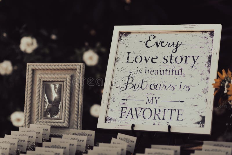 Rustic Wedding Sign Adorned with a Love Quote and Floral Decorations ...