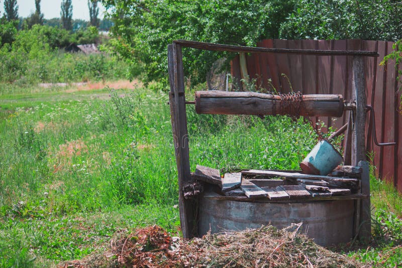 Rustic Well in the Countryside with Trees and Grass Stock Image - Image ...